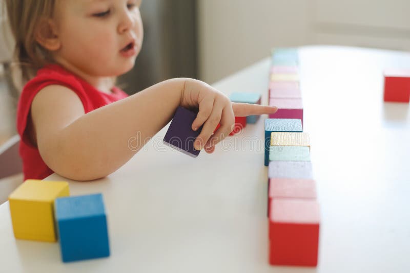 Child Playing and Building with Colorful Wooden Toy Bricks on White ...