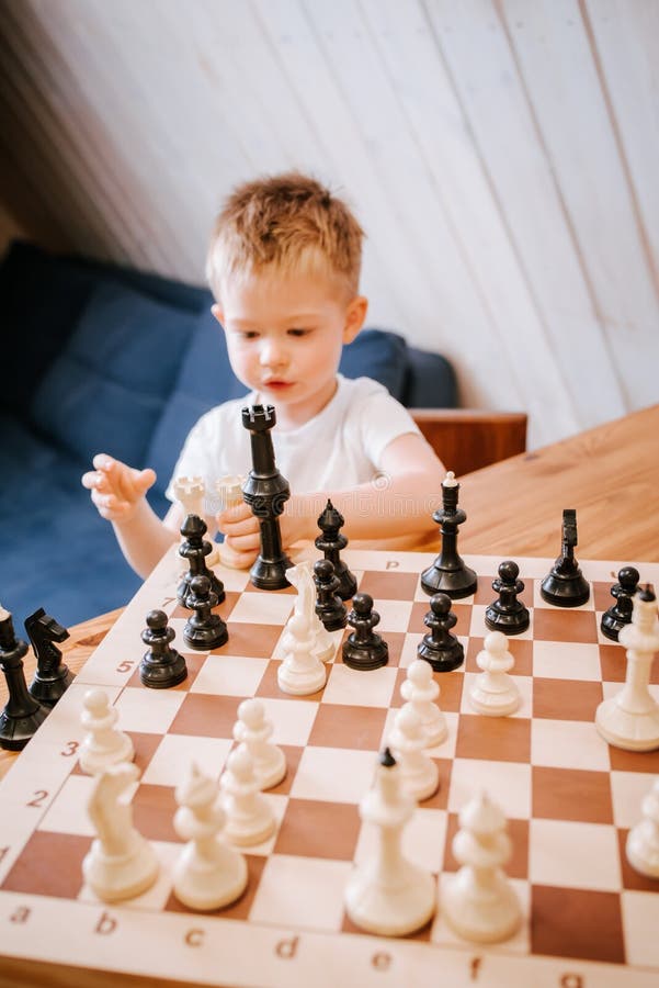 Child Playing Chess at Home at the Table Stock Photo - Image of ...