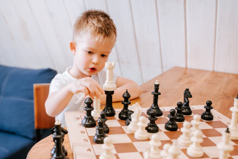 Child Playing Chess at Home at the Table Stock Image - Image of indoor ...