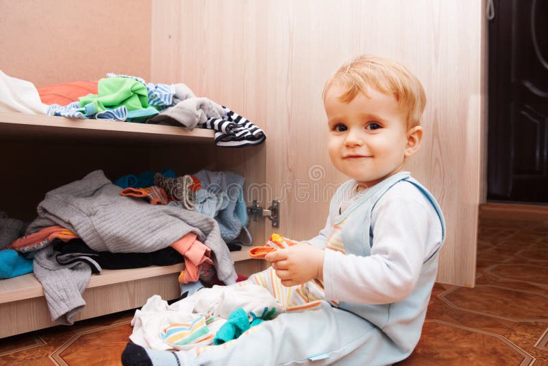 Child playing with clothes stock photo. Image of small - 68223078