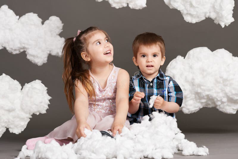 Child Playing with Clouds, Shot in the Studio on a Gray Background ...