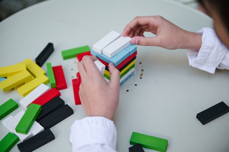 Child Playing with Colorful Blocks on a White Round Table Stock Photo ...