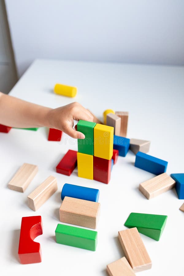 Child Playing with Colorful Wooden Blocks on a White Table Stock Image ...
