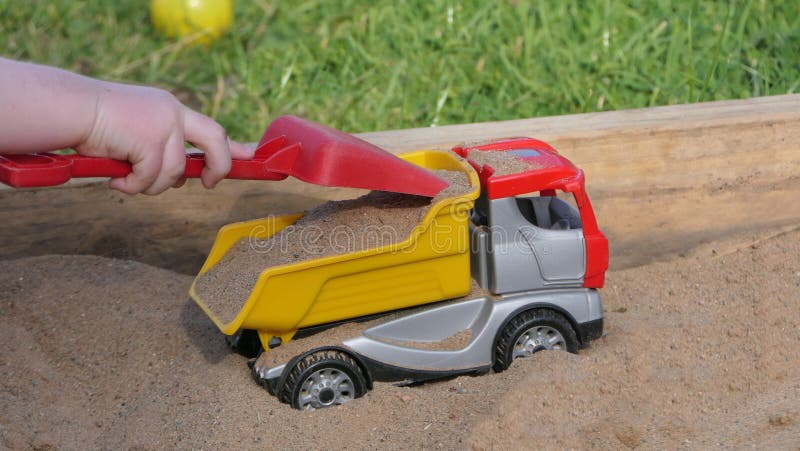 Child Playing Colourful Balls and Buckets in Childs Sand Pit Stock ...