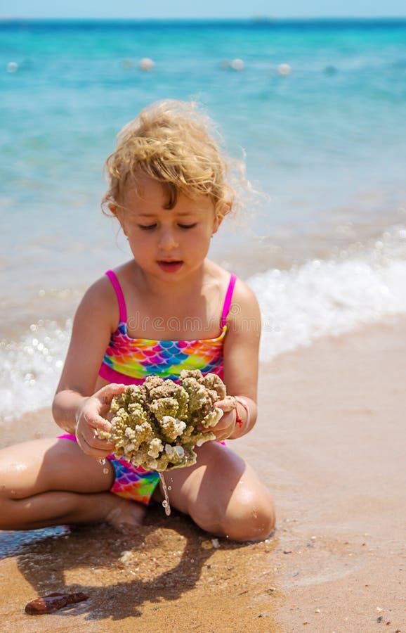 Child Playing with Coral in the Sea. Selective Focus Stock Photo ...