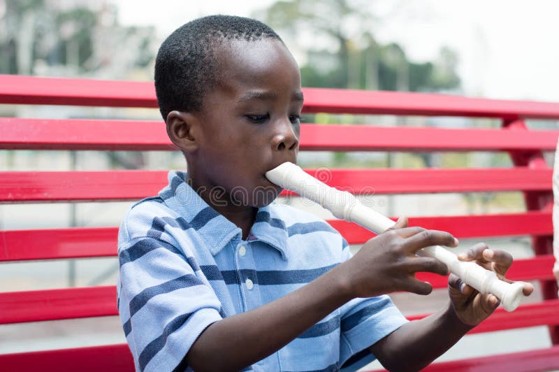 Child playing the flute. stock image. Image of curiosity - 76134929