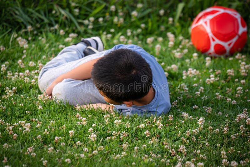 Child Playing Football. One Asian Boy Falling Down Stock Image - Image ...