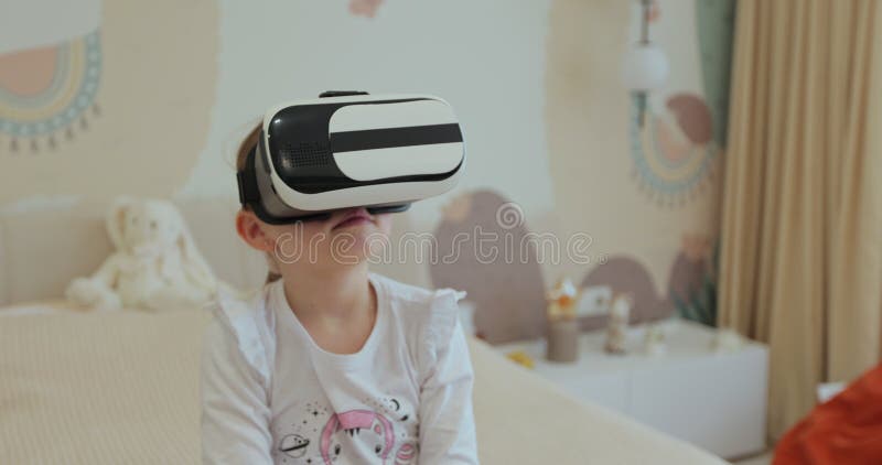 Child Playing Games on Virtual Reality Device. Girl Learning Using ...
