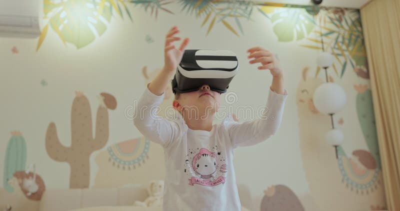 Child Playing Games on Virtual Reality Device. Girl Learning Using ...