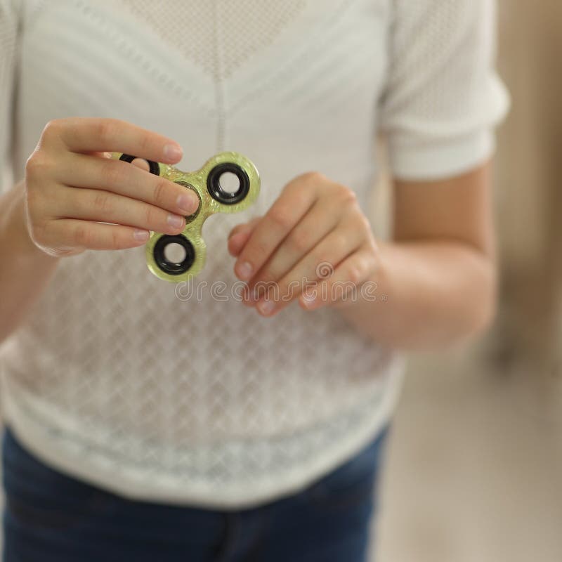 Child Playing with Green Fidget Spinner Closeup Hands in Bright Room ...