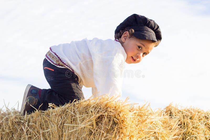 Child Playing in a Haystack. Stock Photo - Image of beauty, plant: 50934036