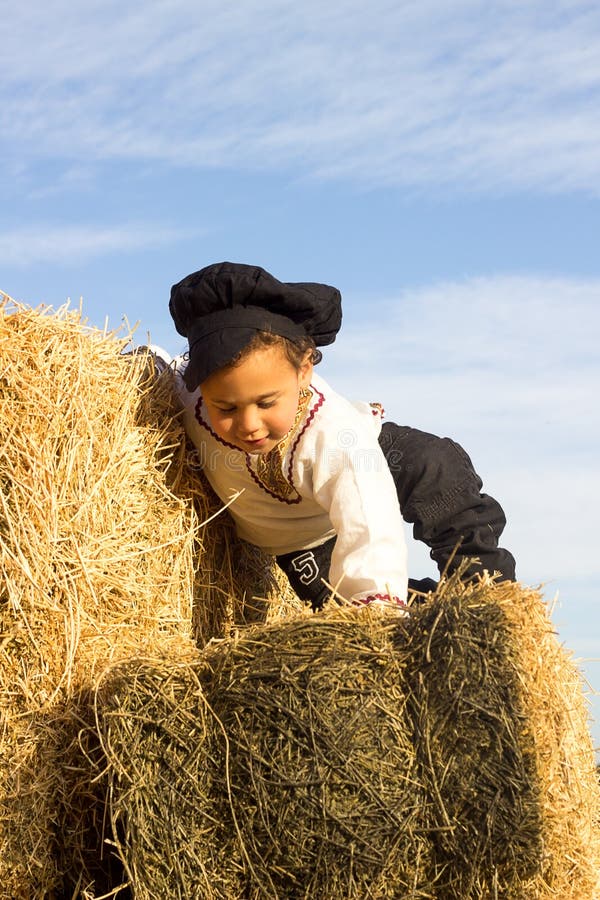 Child Playing in a Haystack. Stock Photo - Image of harvest, life: 50941946