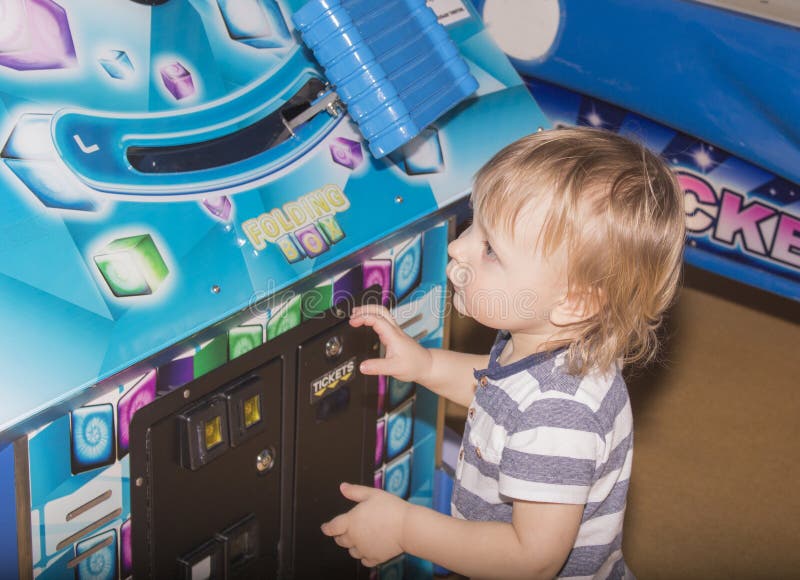 Child Playing on the Kids Game Machine at an Amusement Park Stock Photo ...