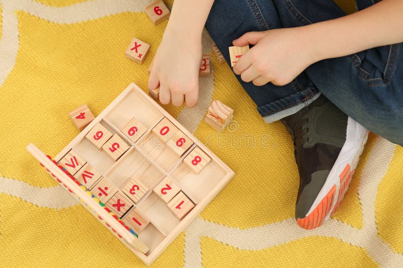 Child Playing with Math Game Kit on Floor, Top View. Learning ...