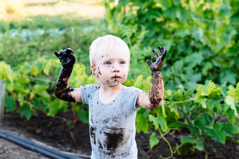 Child Playing in the Mud on the Street Stock Photo - Image of naughty ...