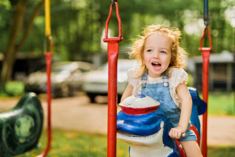 Child Playing on Outdoor Playground. Active Kid on Playground Summer ...