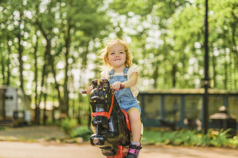 Child Playing on Outdoor Playground. Active Kid on Playground Summer ...