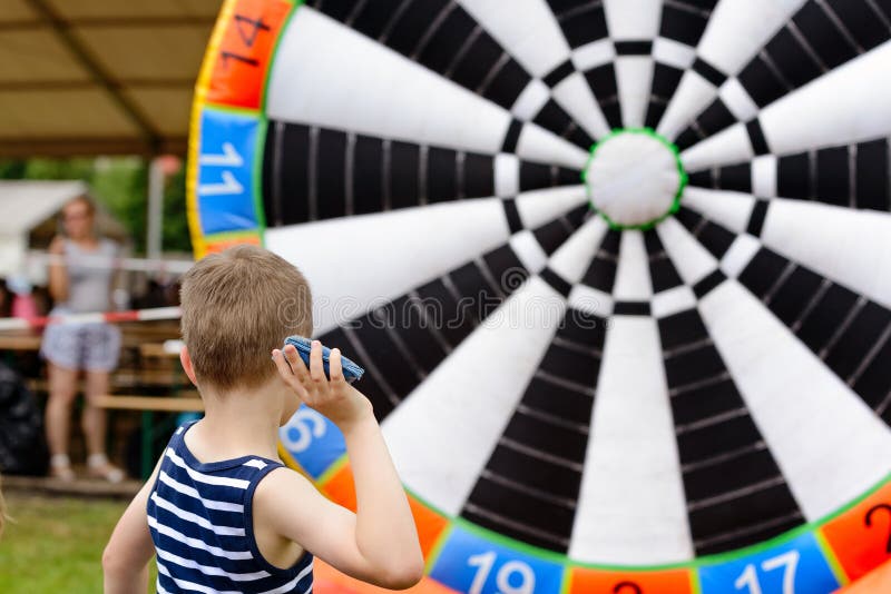 Boy playing darts outdoor stock photo. Image of object - 19458234