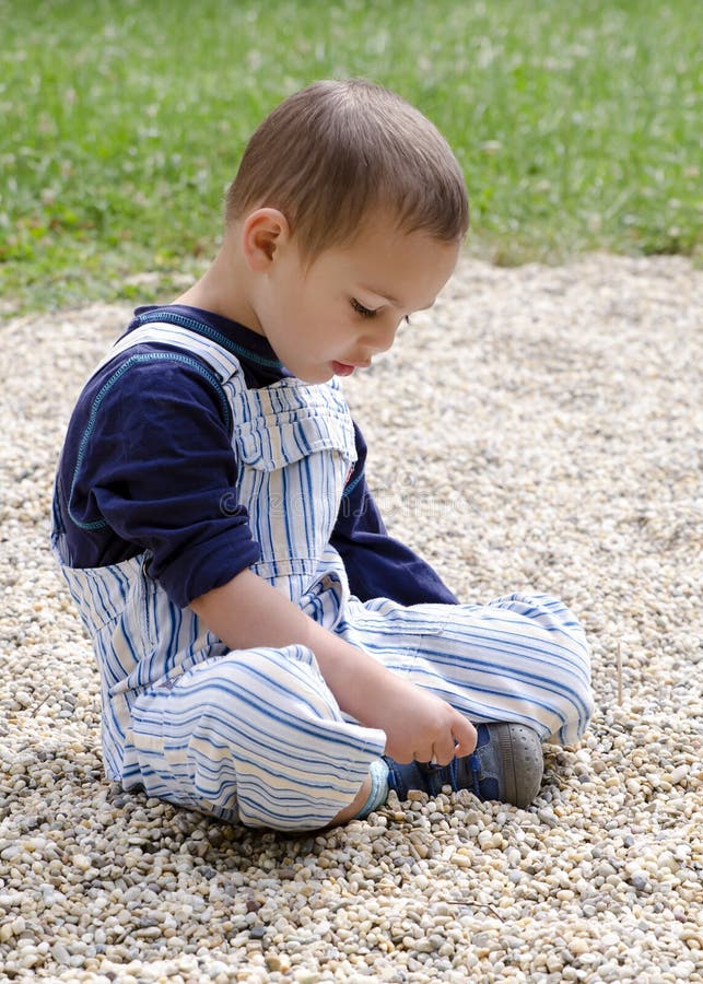 Child playing with pebbles stock image. Image of profile - 48731589