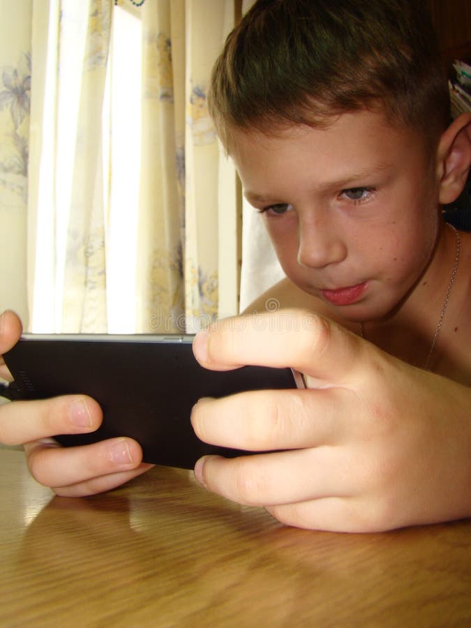 A Child Playing on the Phone Stock Photo - Image of games ...