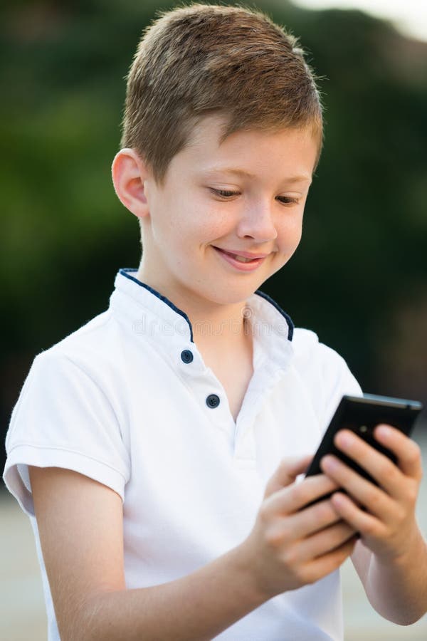 Child playing with phone stock photo. Image of glad, enjoyment - 87307406