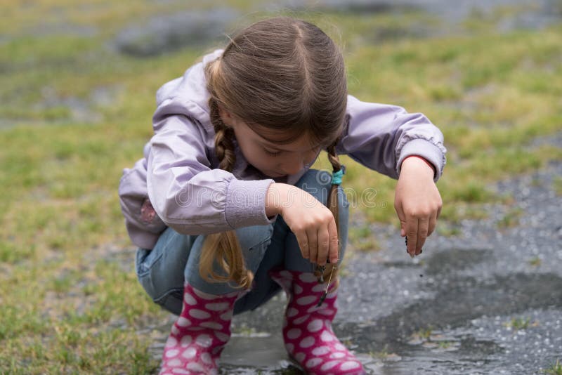 The Child Playing in a Puddle Stock Photo - Image of jumping, innocence ...