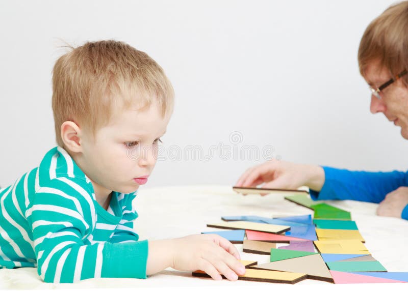 Child playing with puzzle stock image. Image of game - 39998877