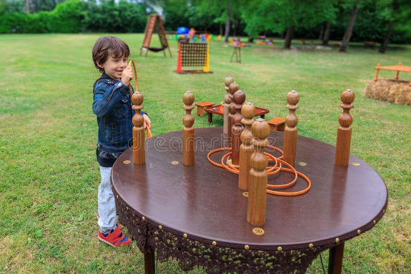 Child Playing Ring Toss Game Outdoors in Park. Recreation and Summer ...