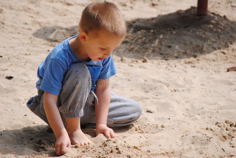 Child playing with sand stock image. Image of summer - 25256211