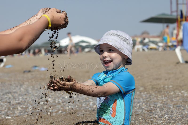 Child playing with sand stock photo. Image of playing - 49840140