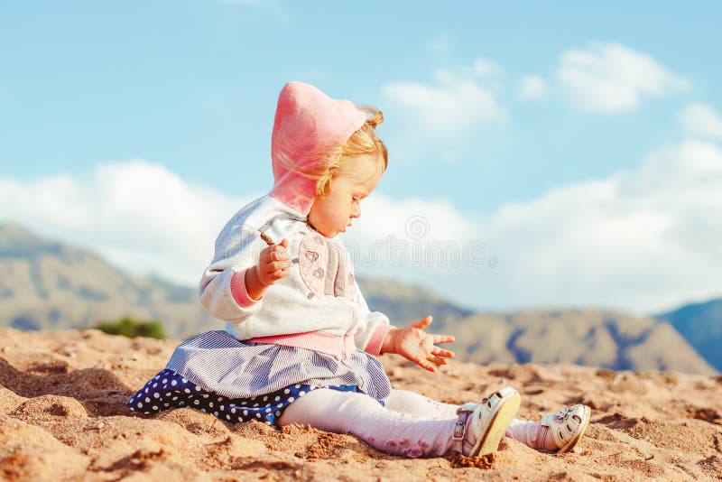 Child playing on the sand stock image. Image of cute - 142682209