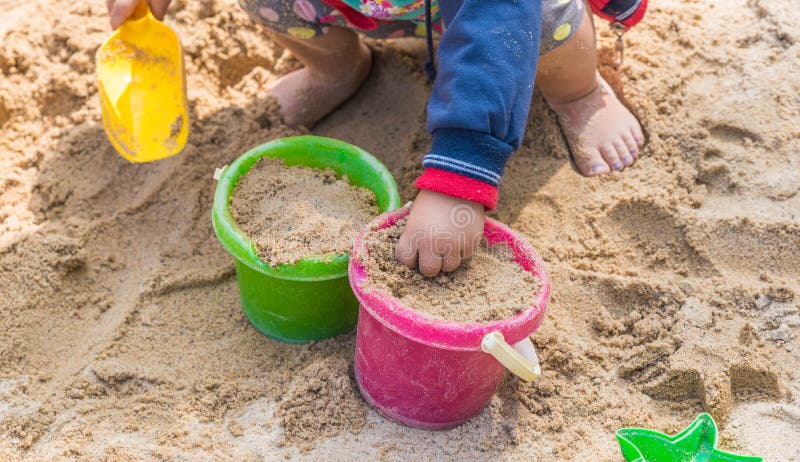 Playing in the sand stock photo. Image of plastic, nature - 100221528