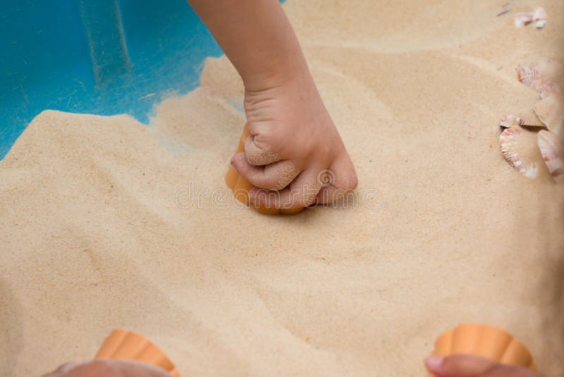 Child Playing in the Sand stock photo. Image of small - 96345272