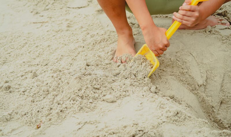 Child Playing Sand with Yellow Shovel at the Beach Stock Image - Image ...