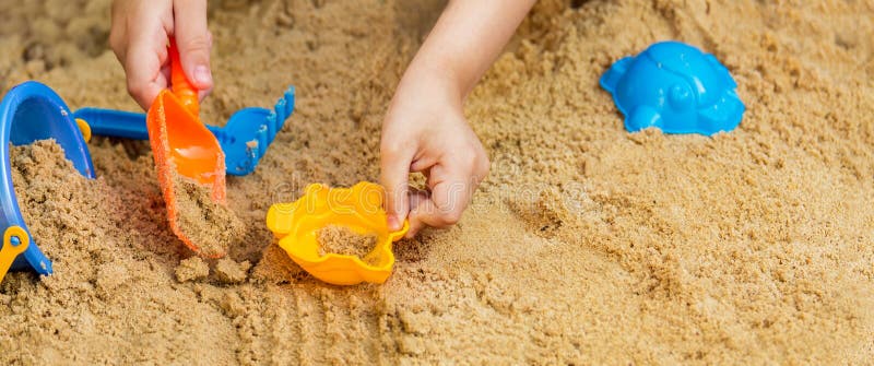 Child Playing in the Sandbox Stock Photo - Image of hold, bucket: 116995486