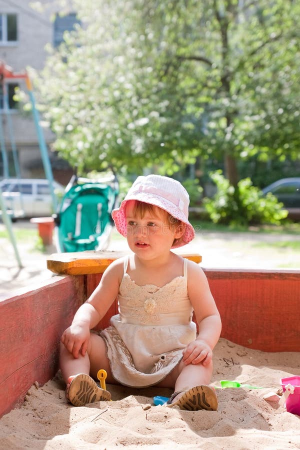 Child playing in sandbox stock image. Image of little - 34196443