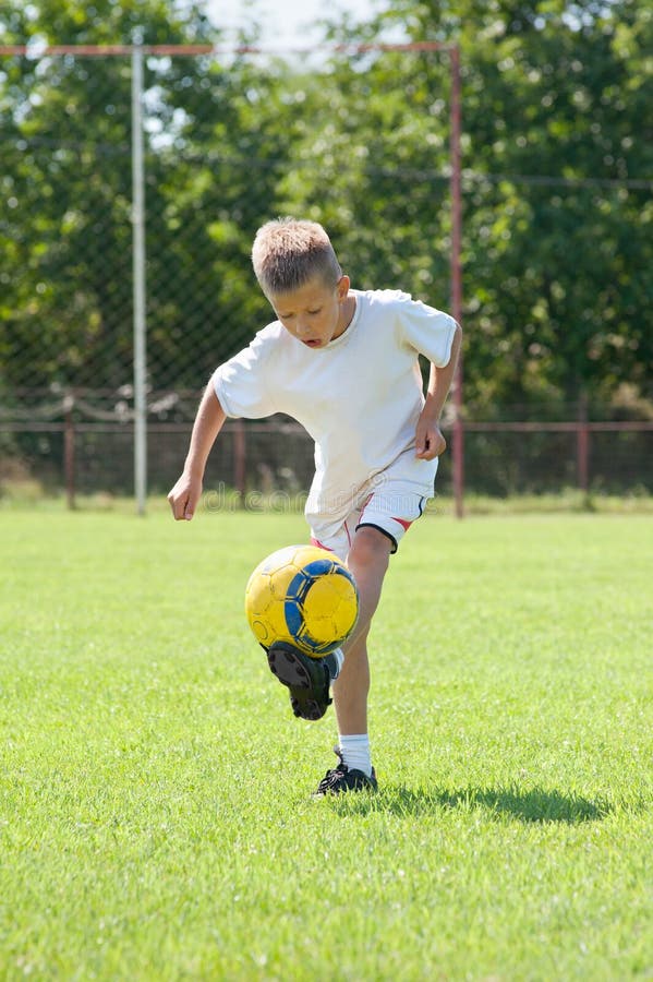 Child playing soccer ball stock image. Image of action - 23969435