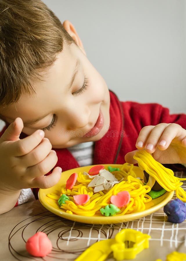 Child Playing with Spaghetti Dish Made with Plasticine Stock Photo ...