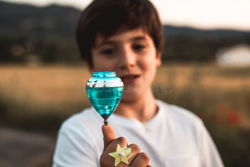 Child Playing Spinning Top. Concept of Happy Playing Children Stock ...