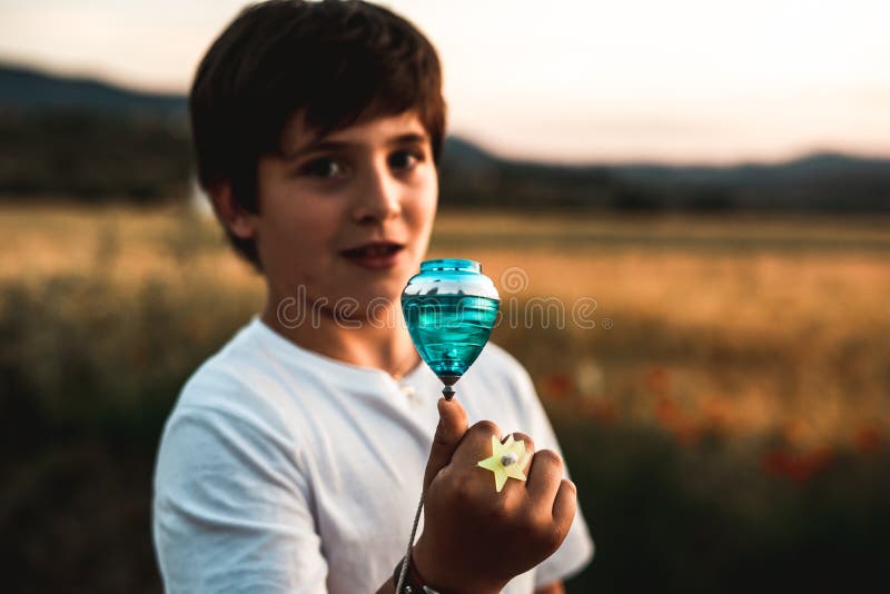 Child Playing Spinning Top. Concept of Happy Playing Children Stock ...