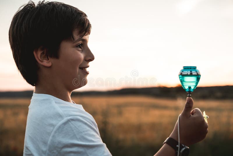 Child Playing Spinning Top. Concept of Happy Playing Children Stock ...