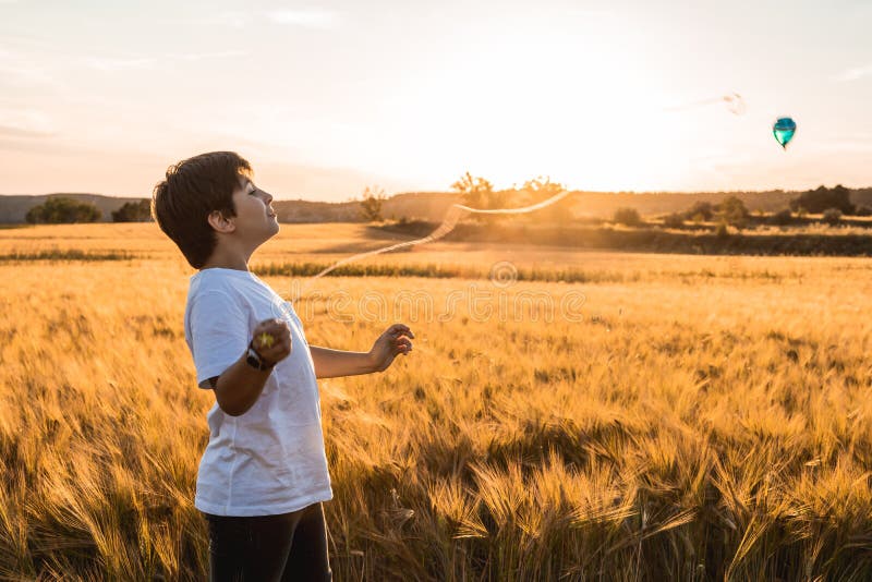 Child Playing with a Spinning Top on the Field Stock Photo - Image of ...