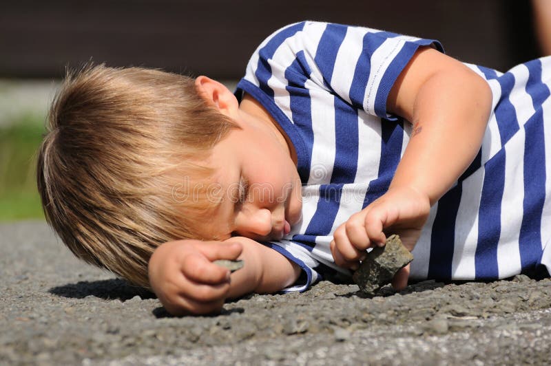 Child playing with stone stock image. Image of little - 26697139