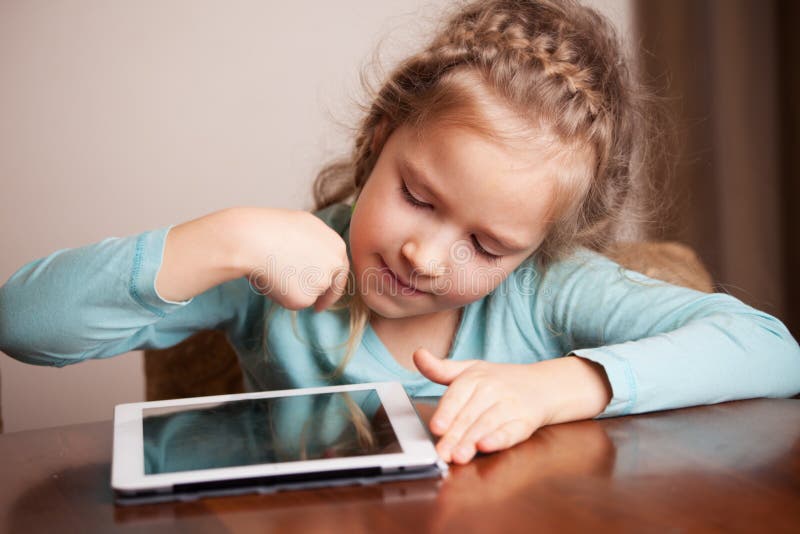 Child playing on tablet pc stock image. Image of cute - 32966693