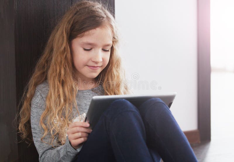 Child playing at tablet stock image. Image of home, lifestyles - 184086249