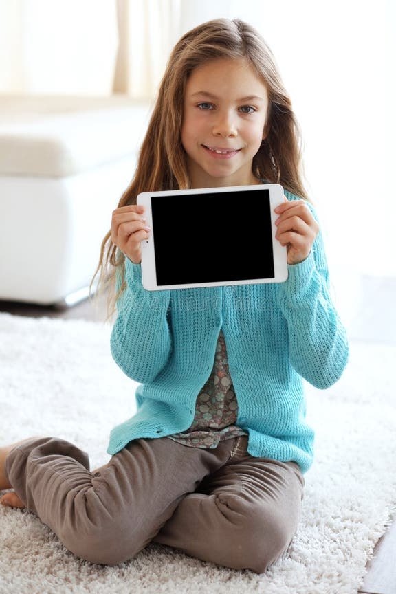 Child playing on tablet pc stock photo. Image of comfortable - 37393930