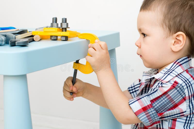 Child playing in tools stock photo. Image of playing - 52552356
