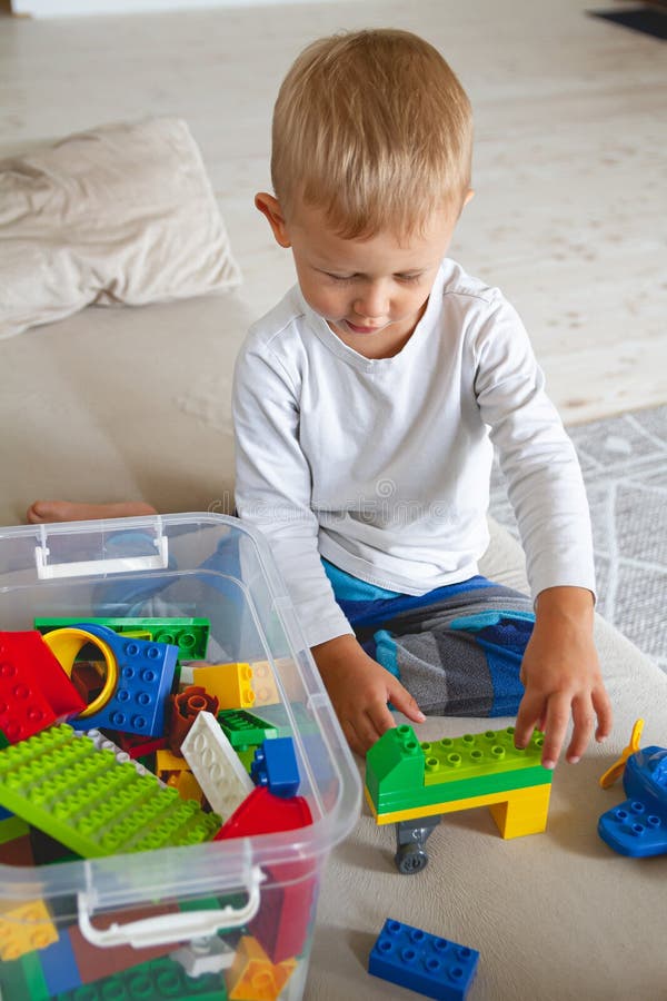 Child Playing with Toy Blocks Sitting on Sofa Stock Photo - Image of ...