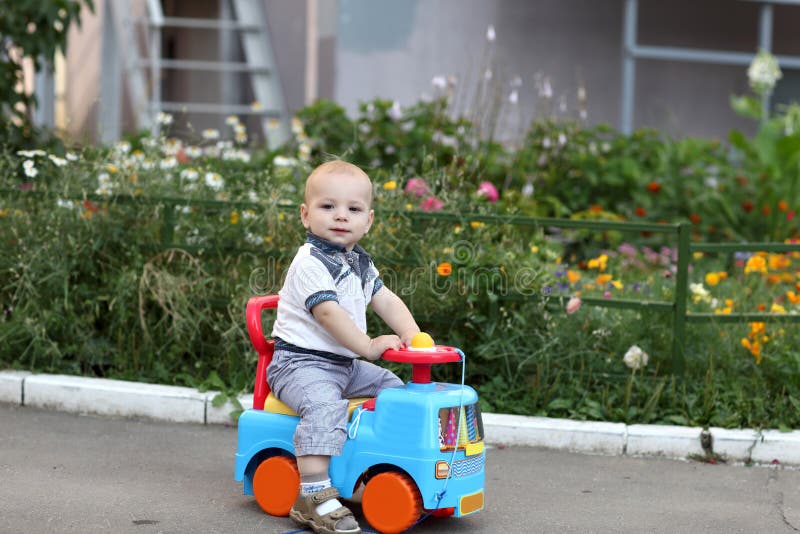 Child playing on toy car stock image. Image of playing - 26090521