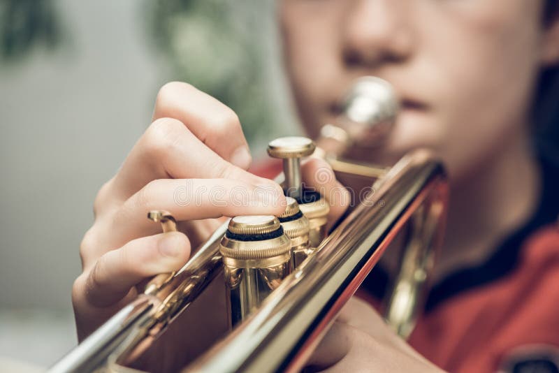 Child playing a trumpet stock image. Image of lesson - 211368723